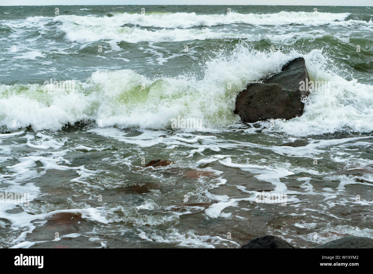 the waves beat against the rocks, the waves splash on the shore Stock ...