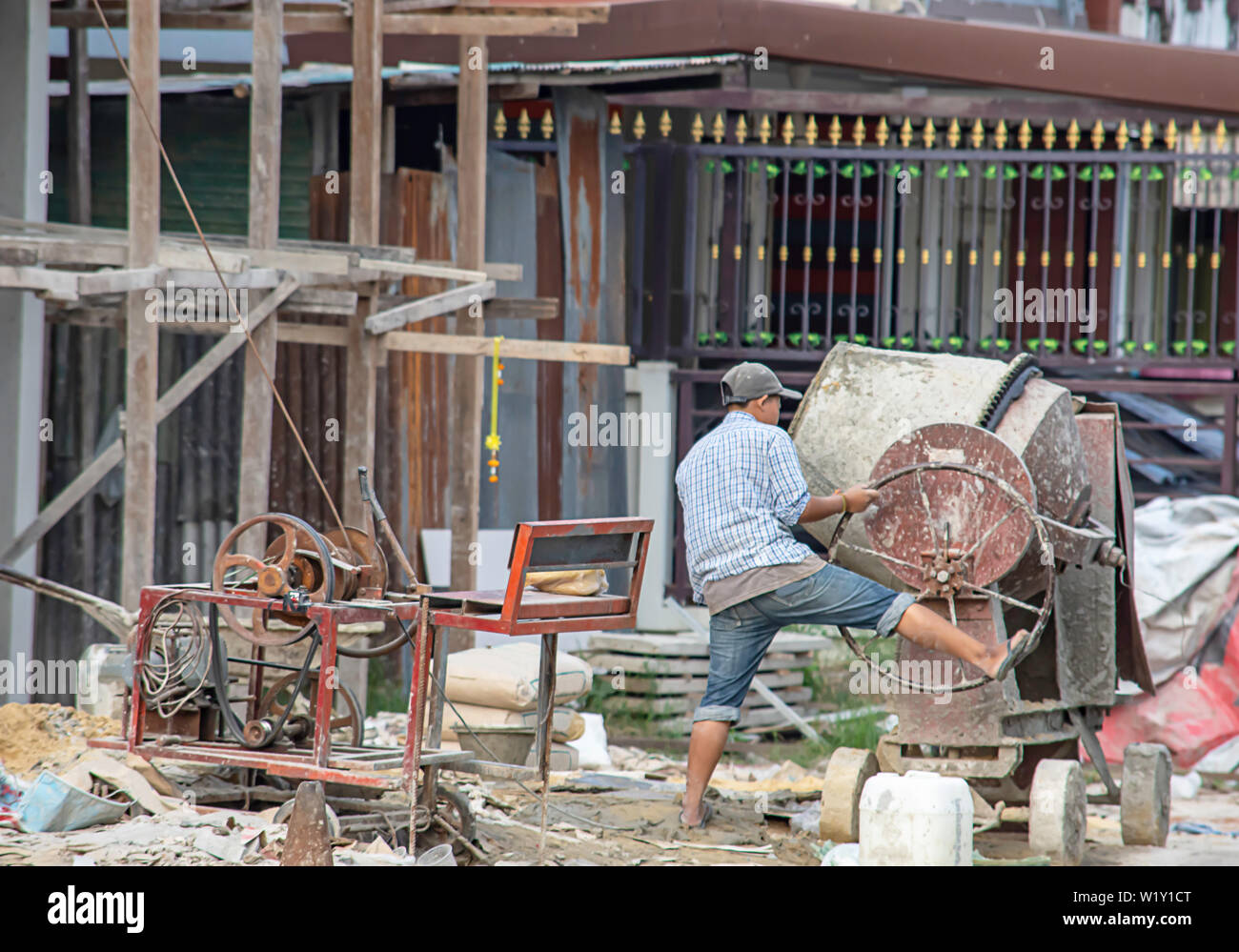 The workers are mixing cement in a cement mill Stock Photo - Alamy