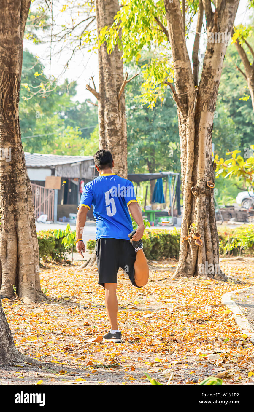 Asean man is warmed up before exercise in the park Stock Photo - Alamy