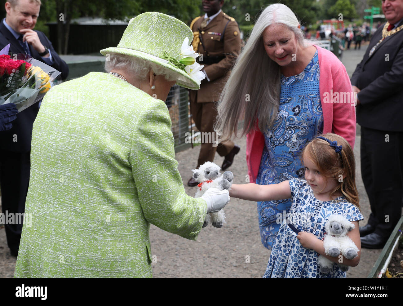 Queen Elizabeth II receives a sheep teddy from Eilidh Fraser (3) during ...