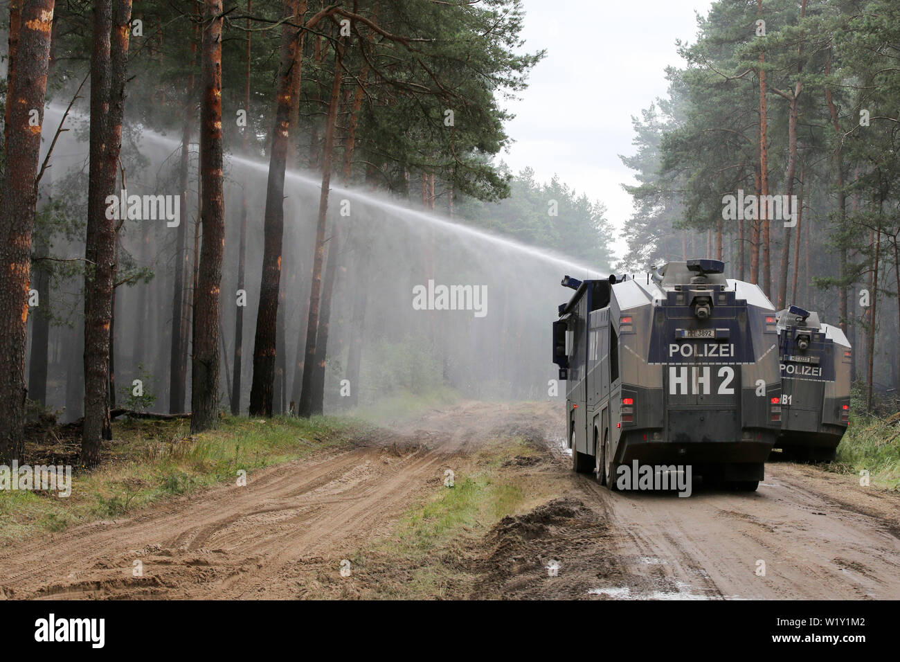 Trebs, Germany. 04th July, 2019. A water cannon extinguishes glowing ...