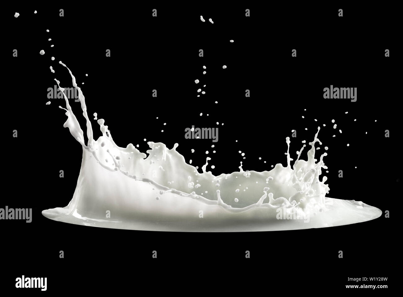 milk splash isolated on black background Stock Photo - Alamy