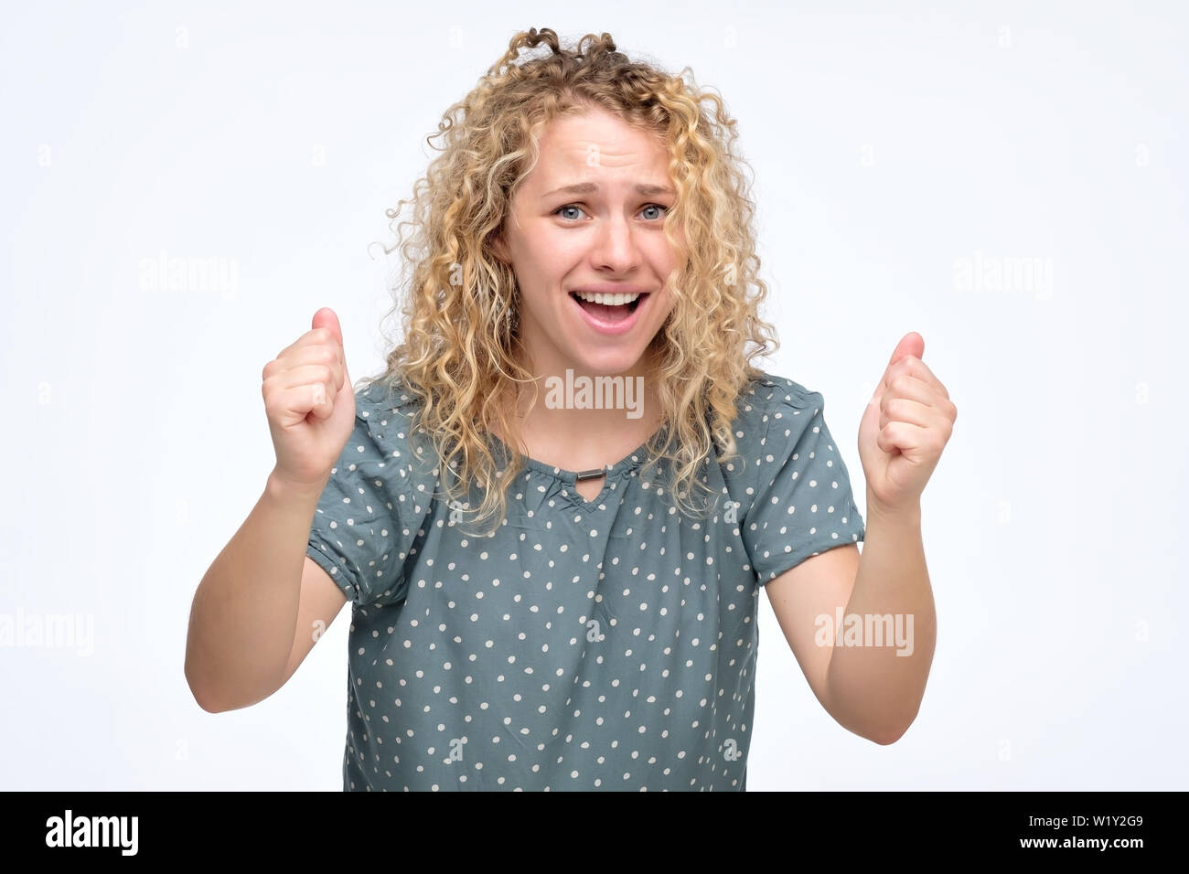 woman in casual clothes shouting yes and raising fists up Stock Photo ...
