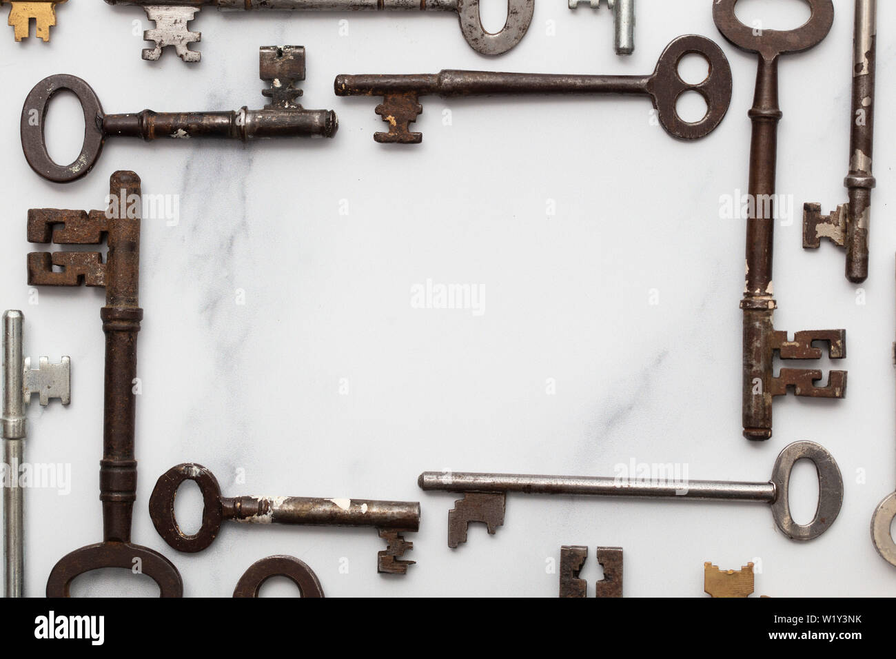 Frame of vintage keys on white background. Safety and security concept ...