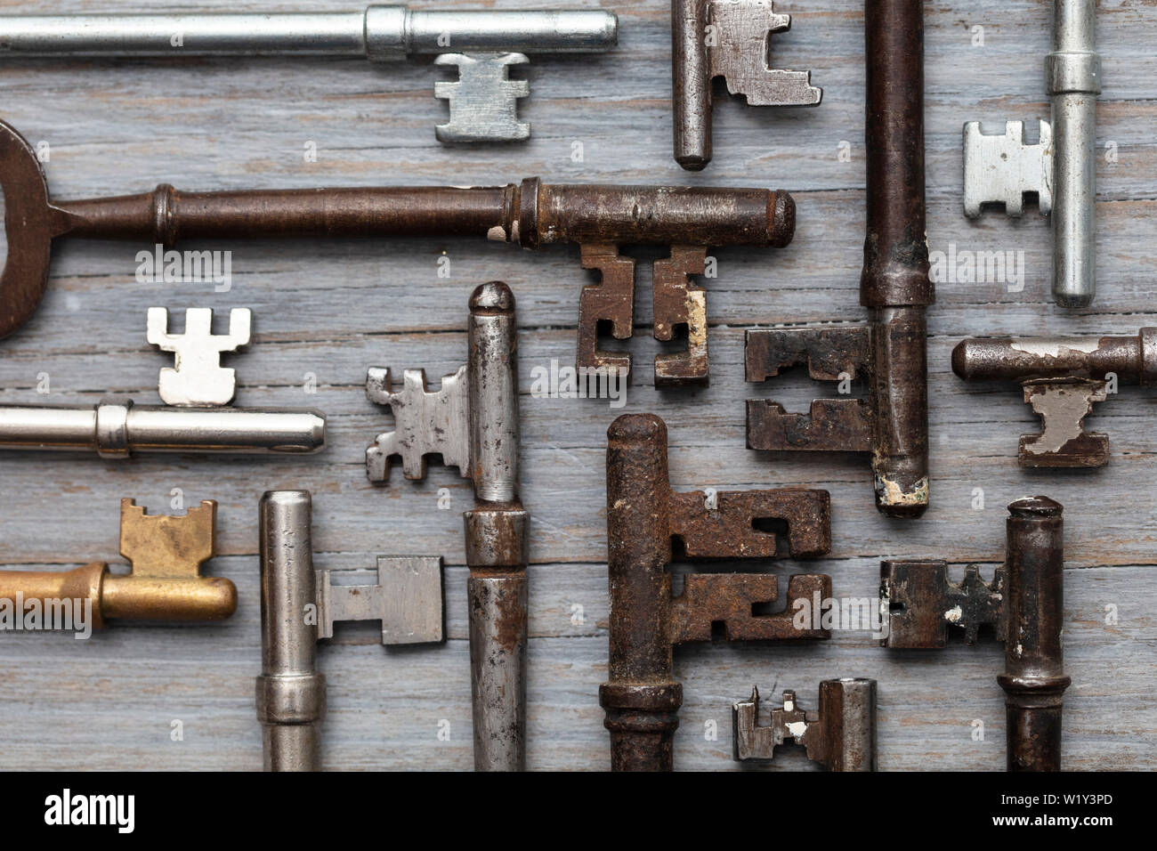 Vintage old fashioned keys on a rustic wooden background. Security ...