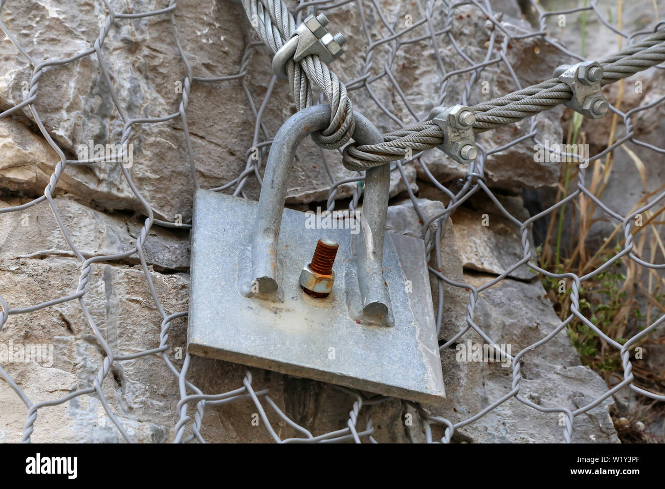 Metal cables are fixed on the rock Stock Photo - Alamy