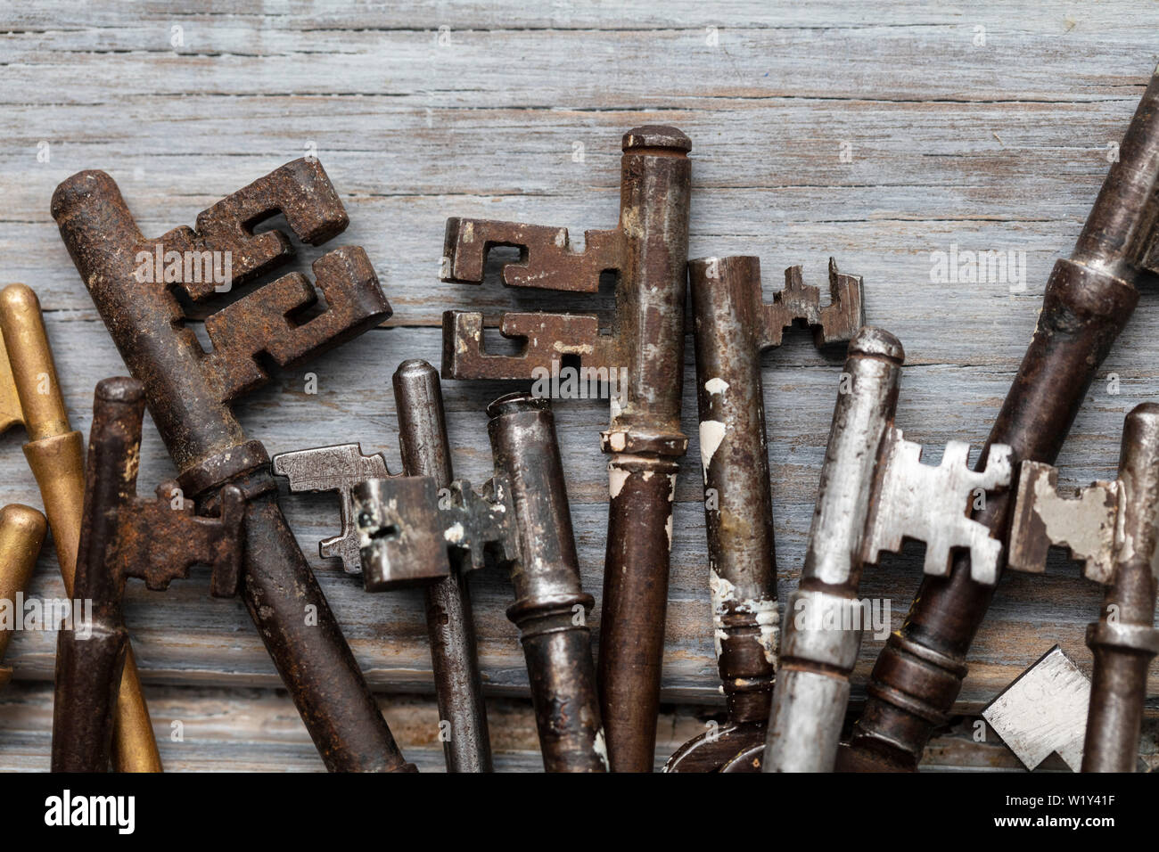 Vintage old fashioned keys on a rustic wooden background. Security ...