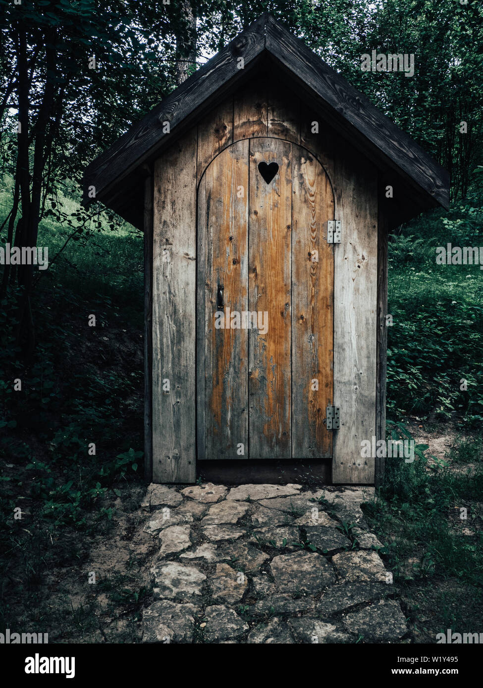 Old wooden restroom in a forest Stock Photo - Alamy