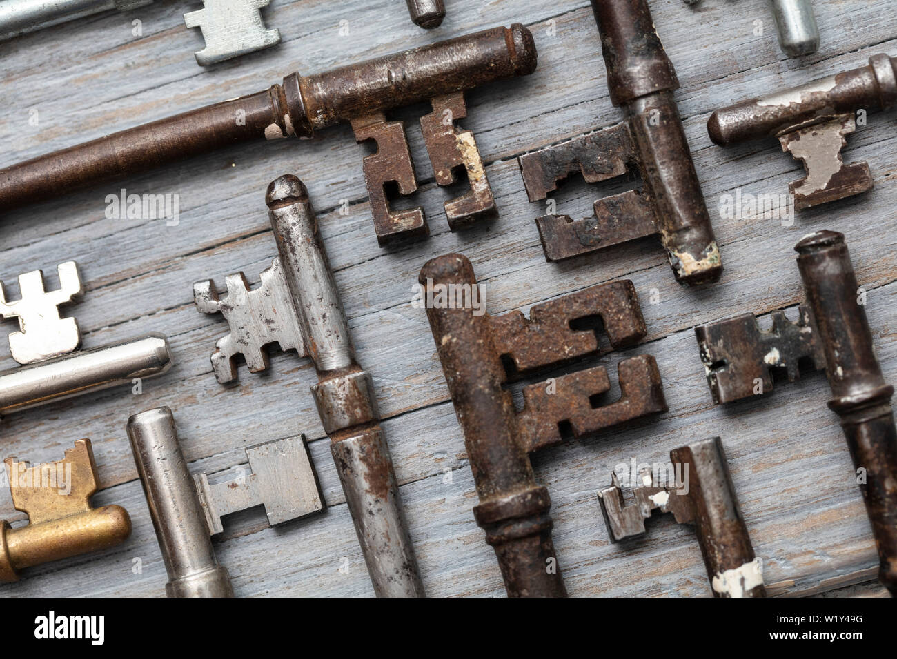 Vintage old fashioned keys on a rustic wooden background. Security ...