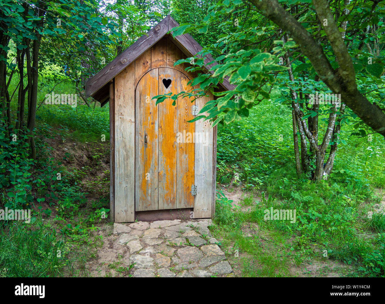 Old wooden restroom in a forest, ecological composting toilet on ...