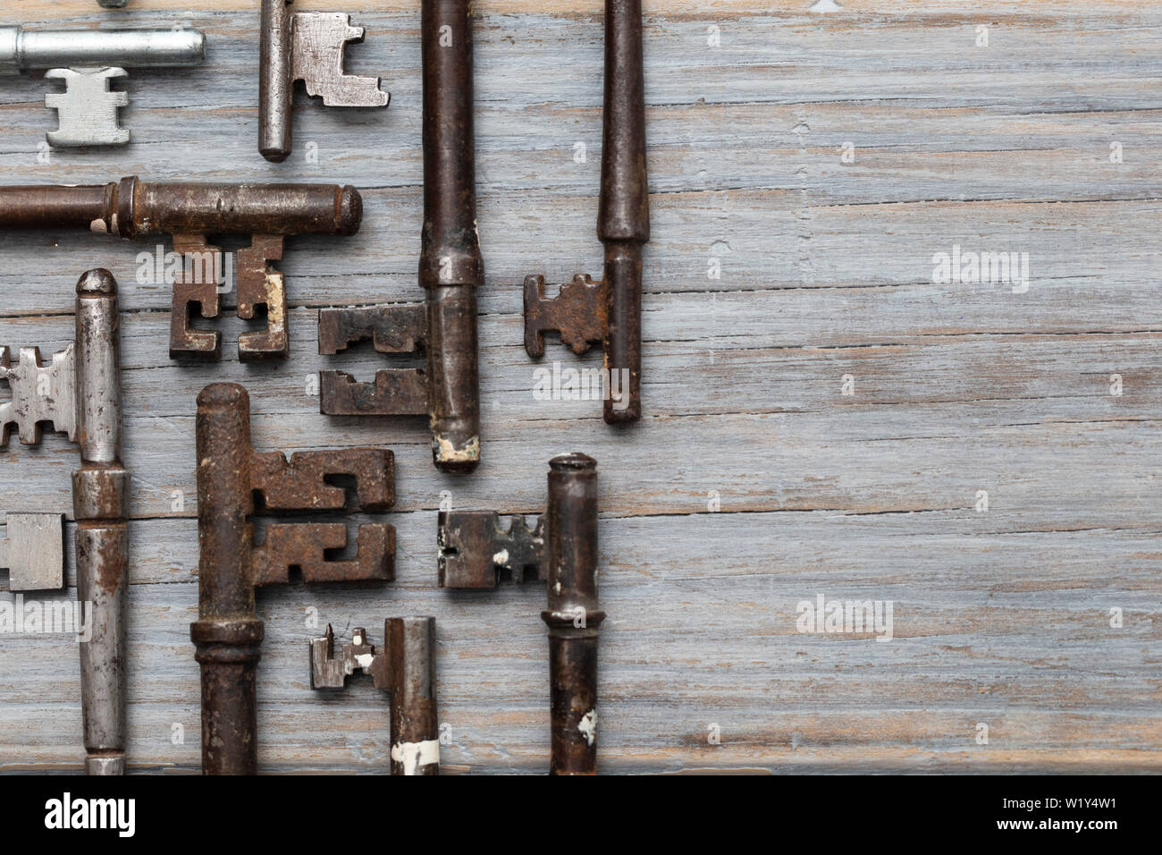 Vintage old fashioned keys on a rustic wooden background. Security ...