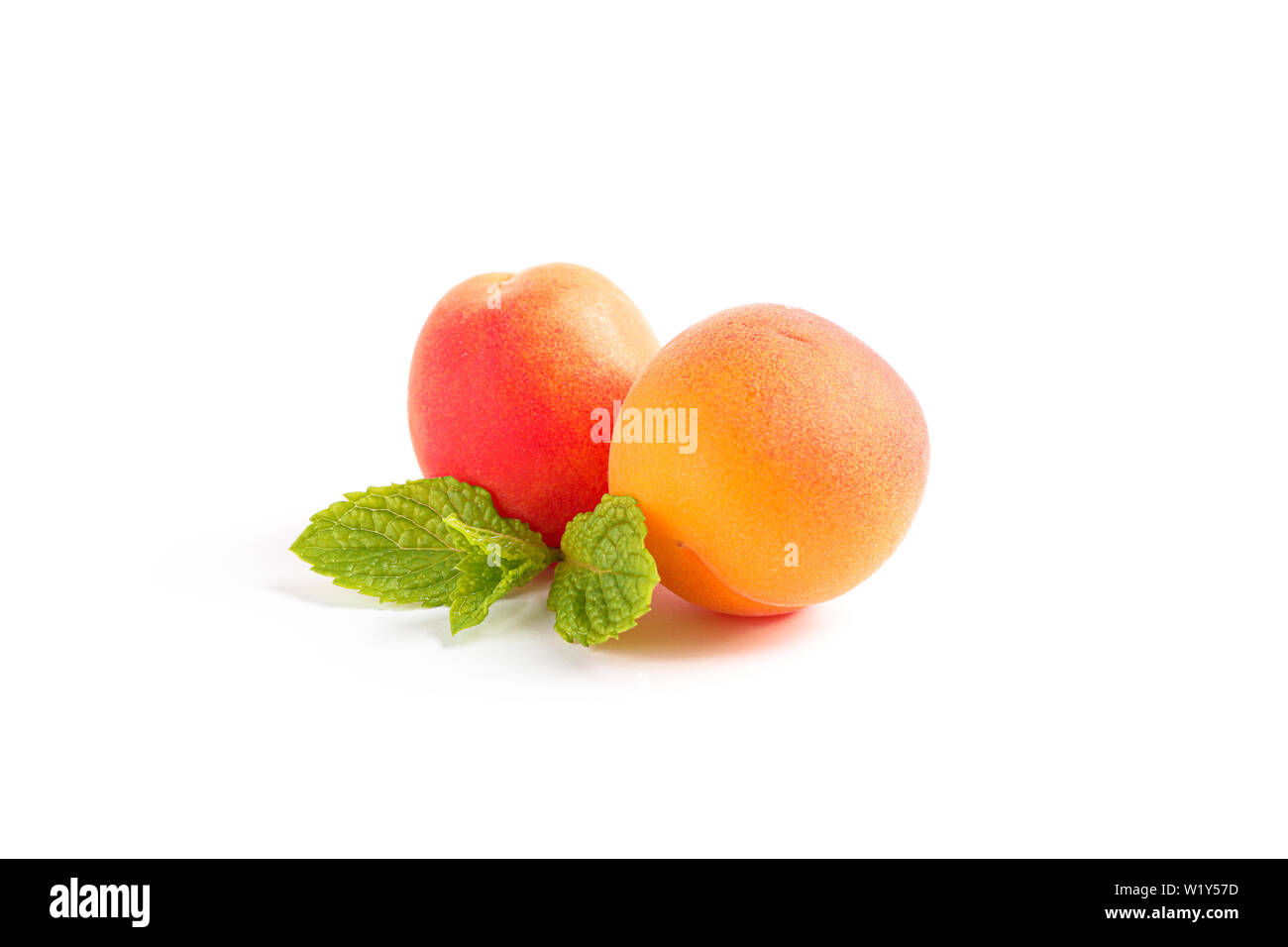 Apricots with mint isolated on white background Stock Photo - Alamy