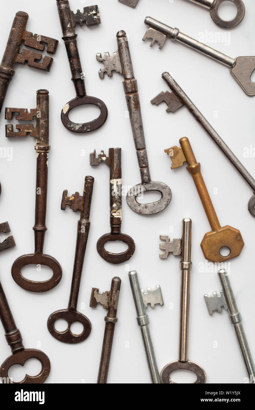 Large set of vintage keys on a plain background. Safety and security ...