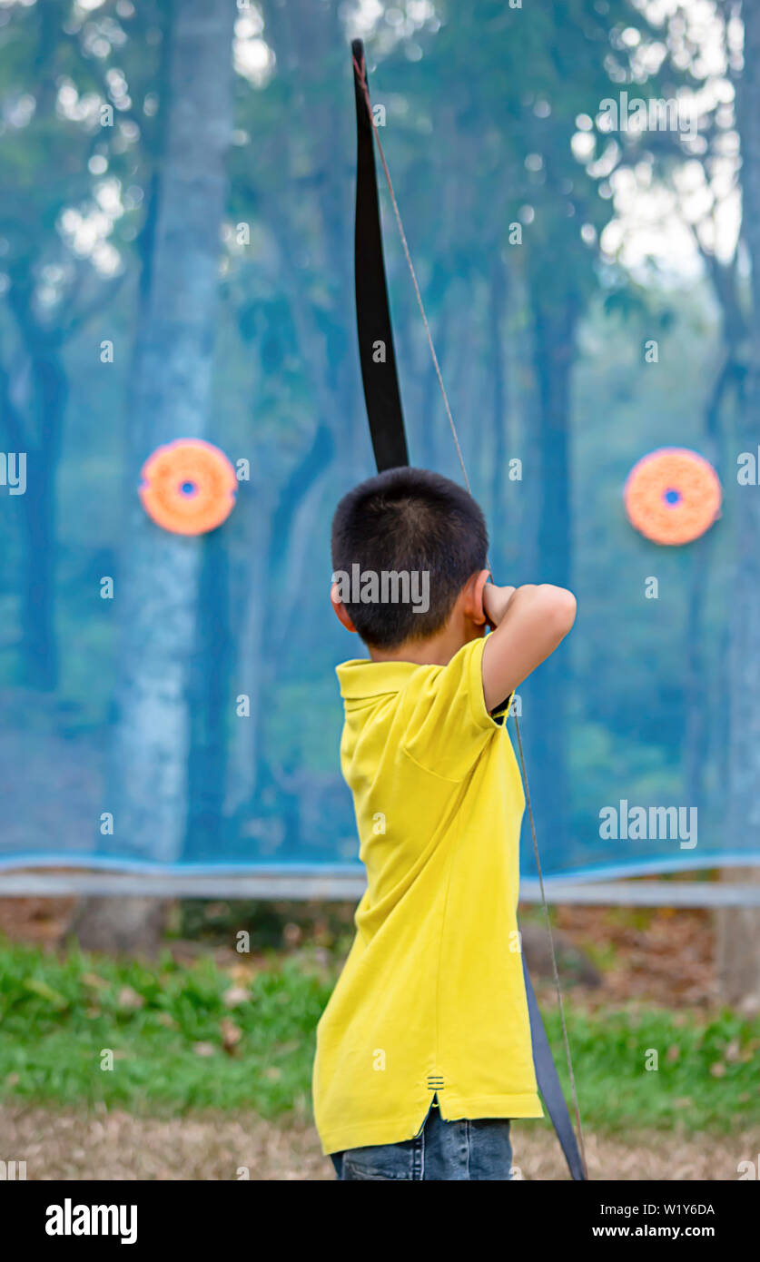 Asian boys are archery in camp adventure Stock Photo - Alamy