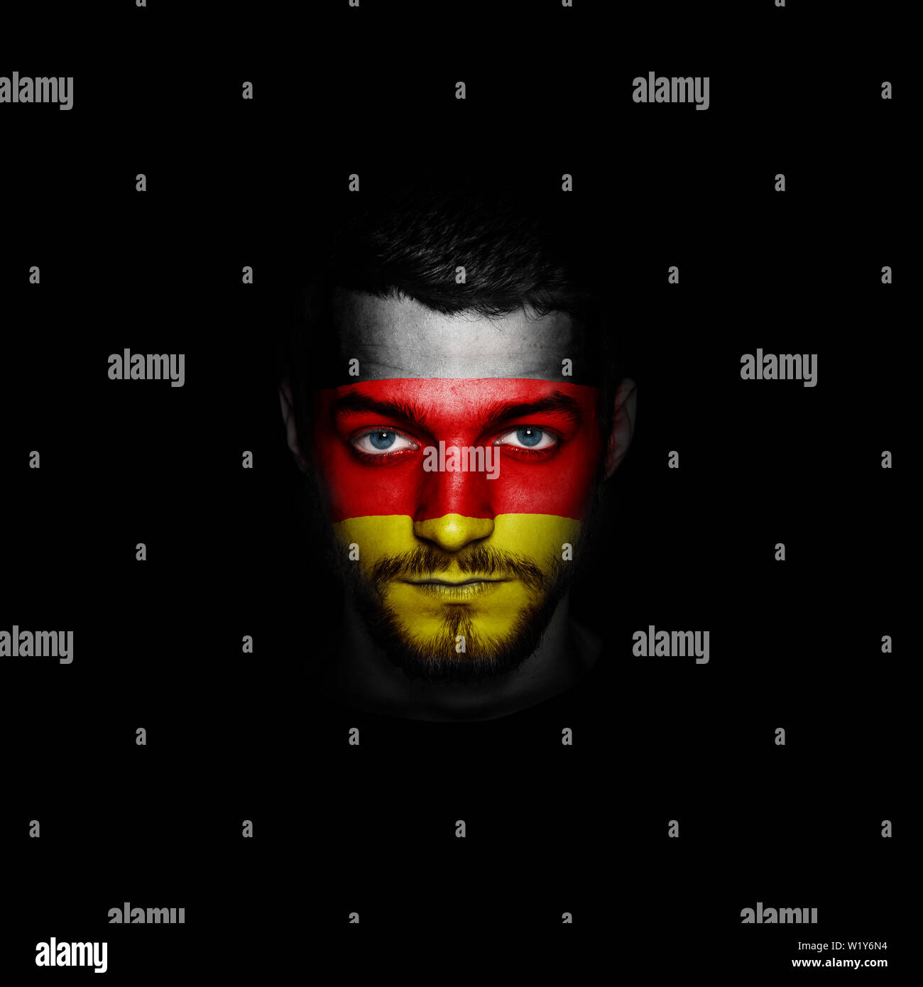 Flag of Germany painted on a face of a man Stock Photo - Alamy