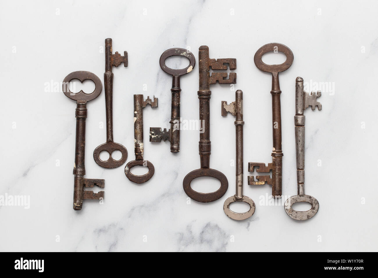 Vintage old fashioned keys on a marble background Stock Photo - Alamy