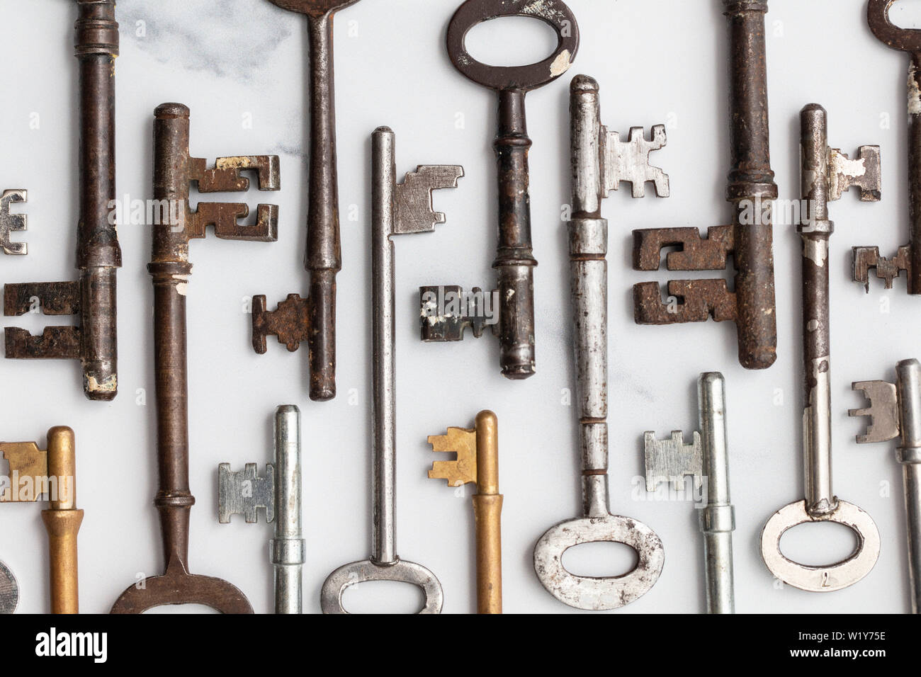 Large set of vintage keys on a plain background. Safety and security ...