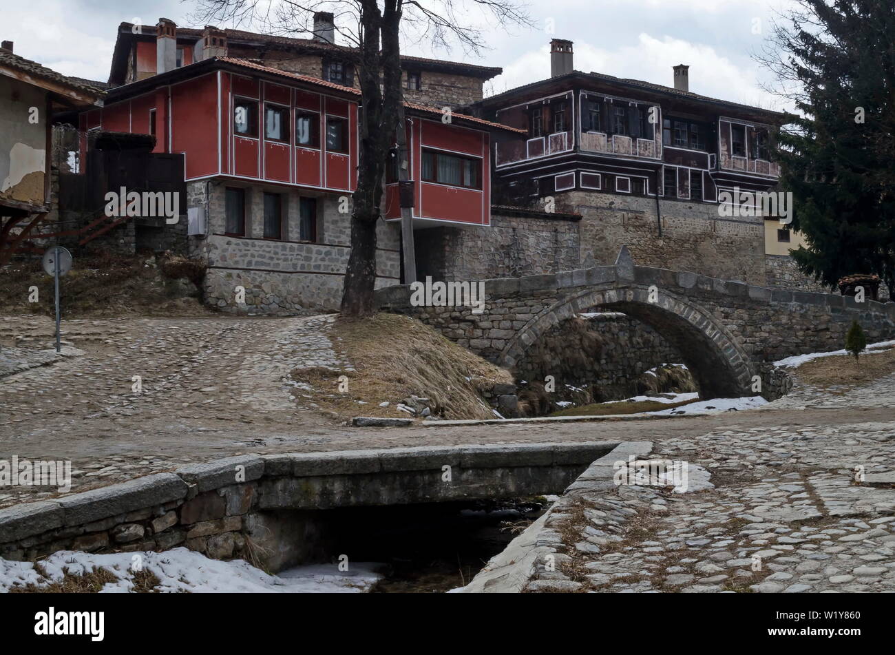 View toward authentic old stone bridge in residential district with ...
