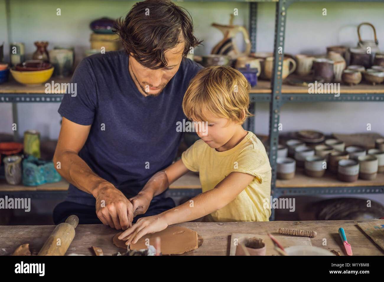 Father and son doing ceramic pot in pottery workshop Stock Photo - Alamy