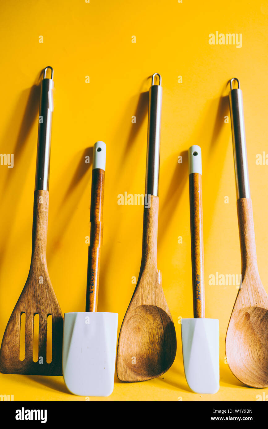 Kitchen foody background, utensil and a white oven container on a brown ...