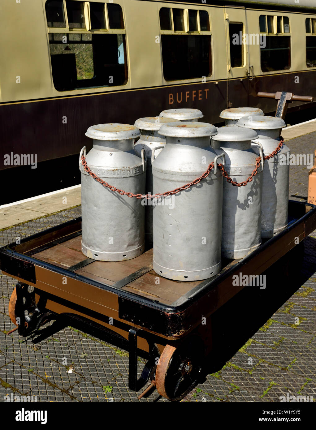 Old-fashioned milk churns on a platform trolley at Totnes Riverside ...