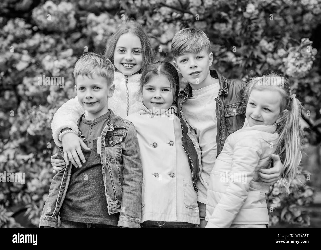 Happy spring vacation. Children enjoy warm spring. Lost in blossom ...