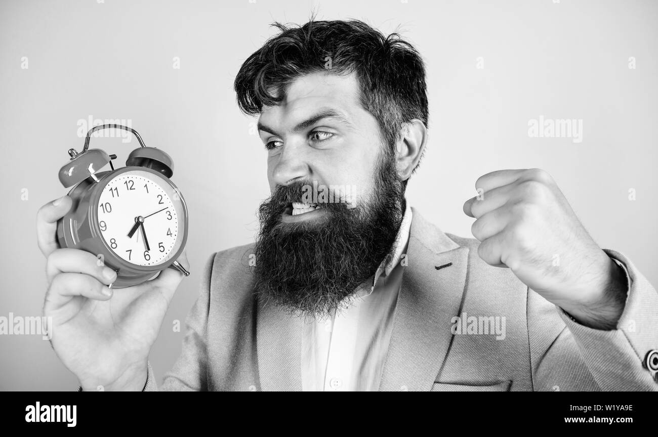 Man bearded aggressive businessman hold clock. Stress concept. Hipster ...