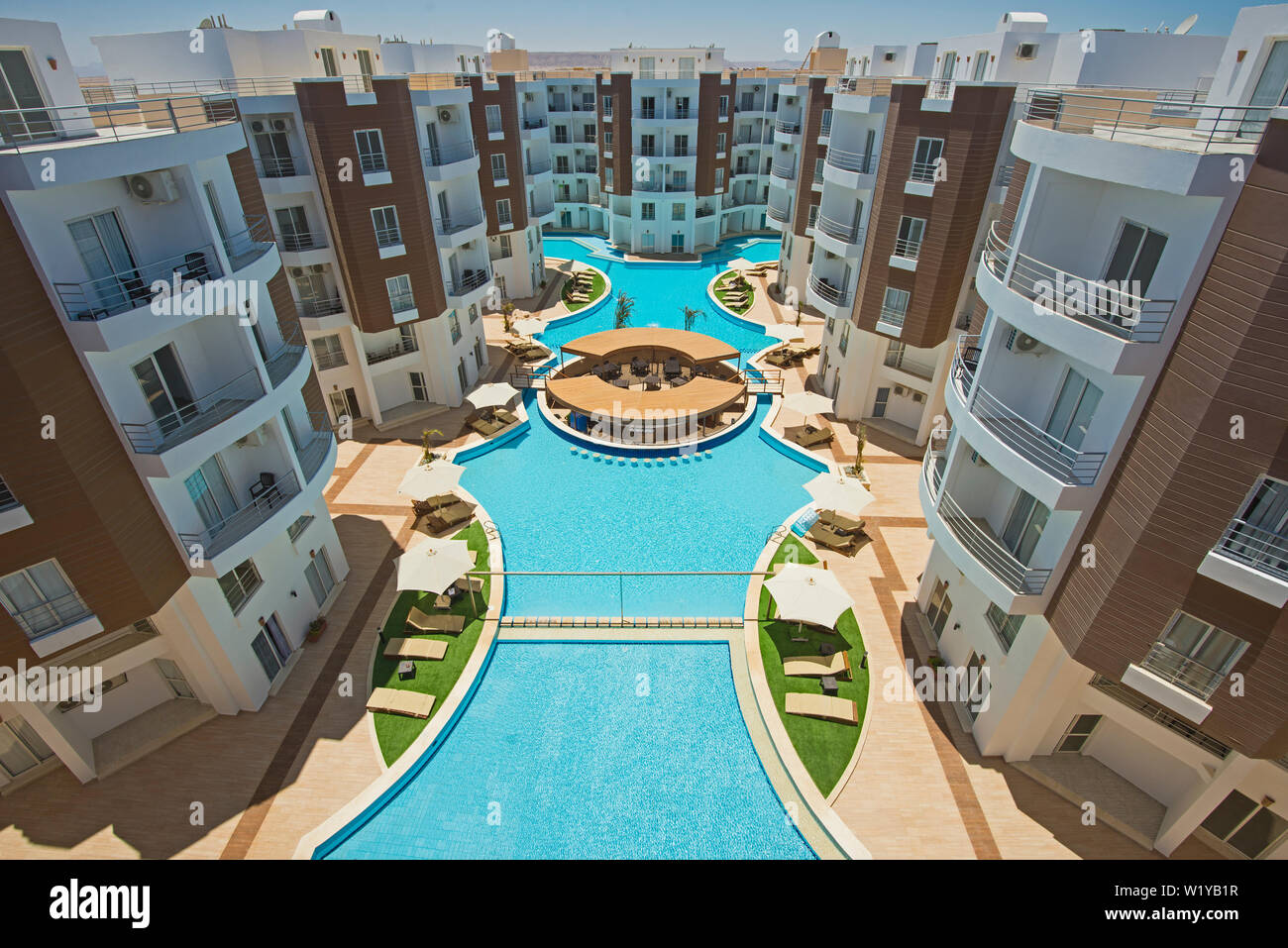 Panoramic aerial view of large swimming pool with bar at a luxury ...