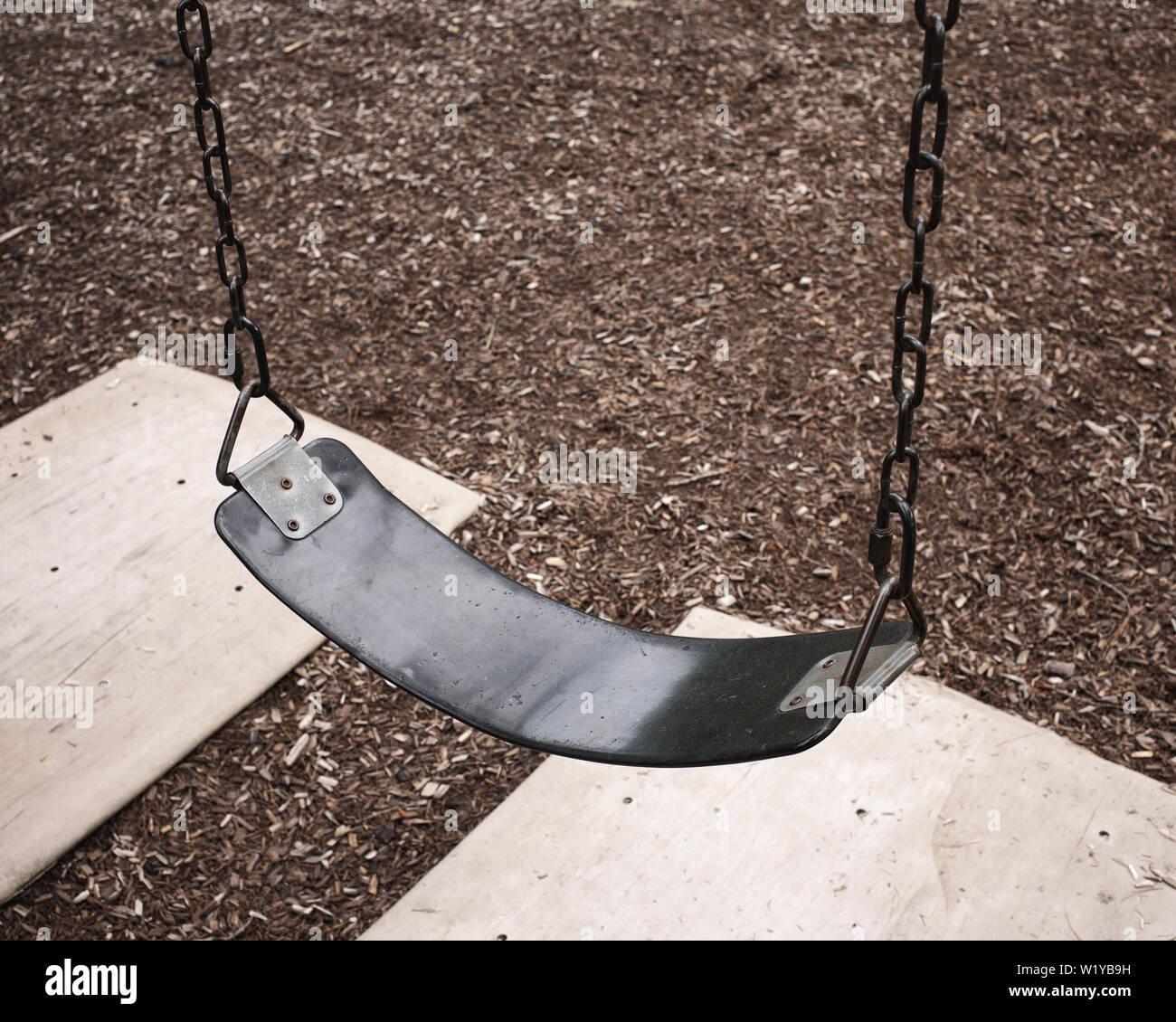 Empty playground swing set concept Stock Photo - Alamy