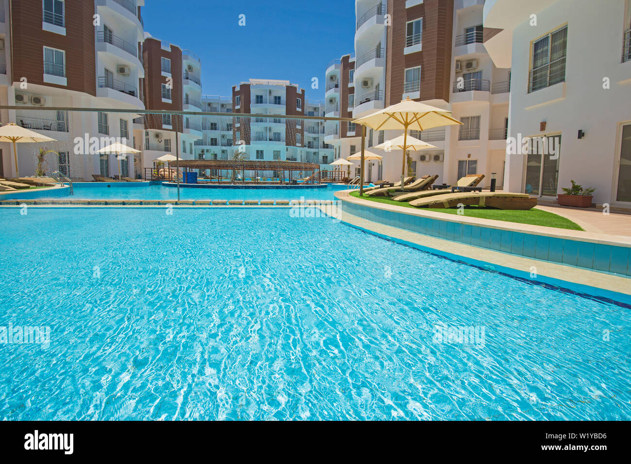 Large swimming pool with bar at a luxury tropical hotel apartment ...
