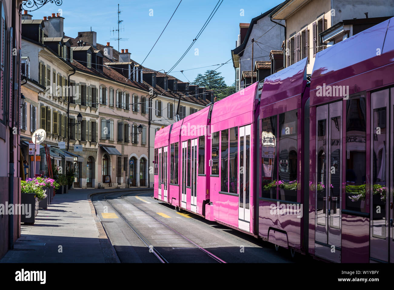 Tram passing through a typical street with French-Italian architecture ...