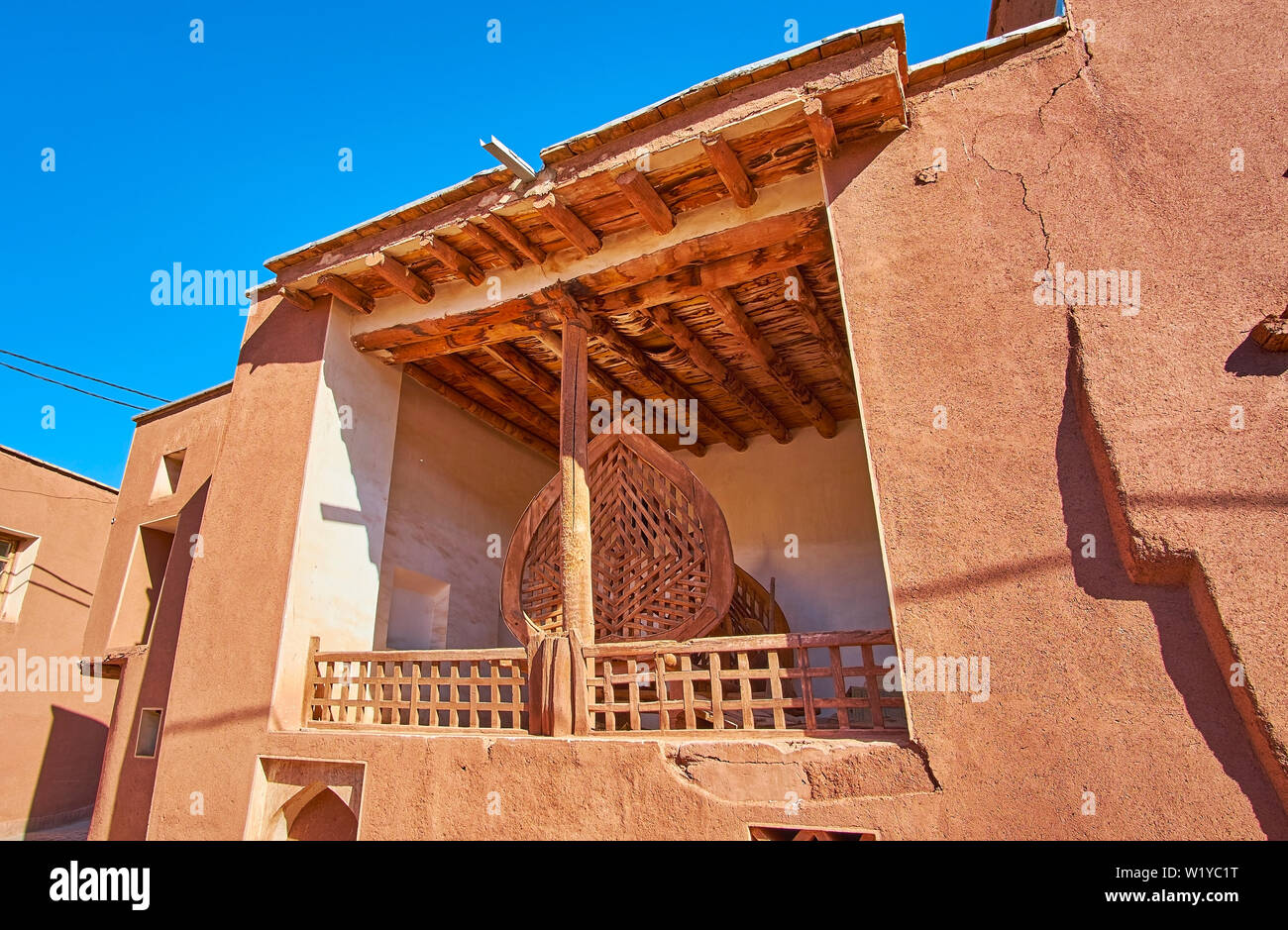 The iwan (portal) of small village mosque with wooden ceiling and ...