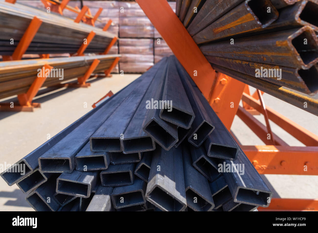 Square steel pipes, stacked on a special stand. Perspective Stock Photo ...