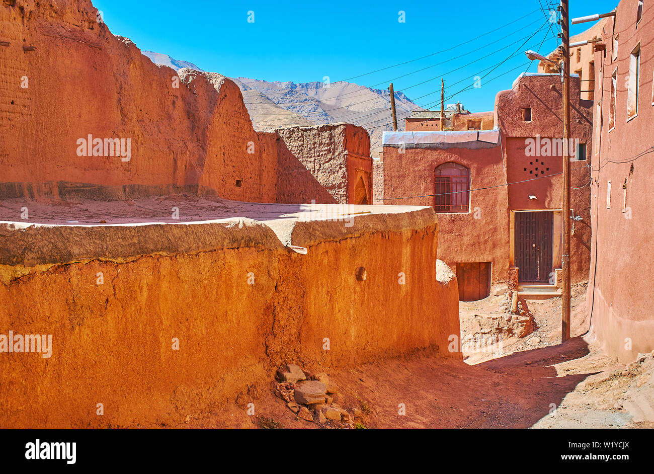The ancient reddish walls of the living houses in mountain Abyaneh ...