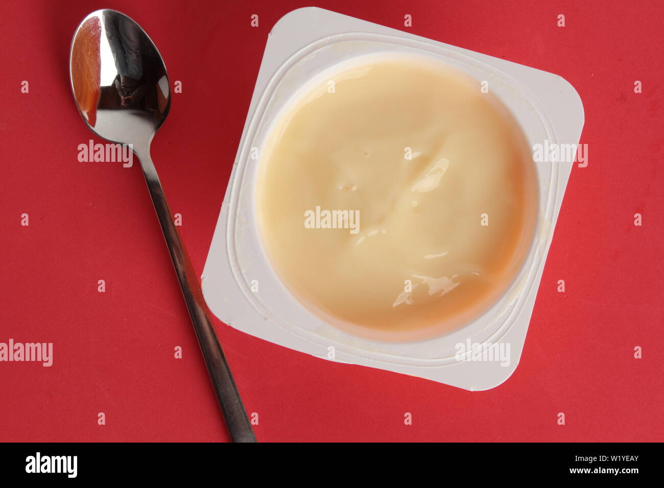 custard packed in plastic container Stock Photo - Alamy