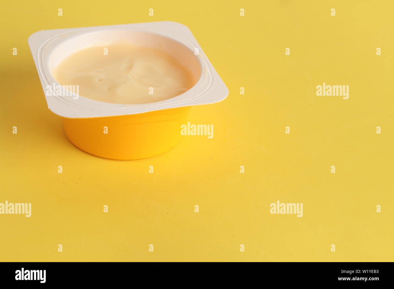 custard packed in plastic container Stock Photo - Alamy