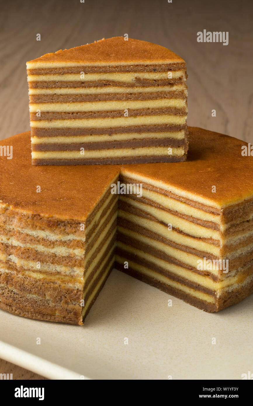 Asian homemade layer cake and a piece on top of the cake Stock Photo ...