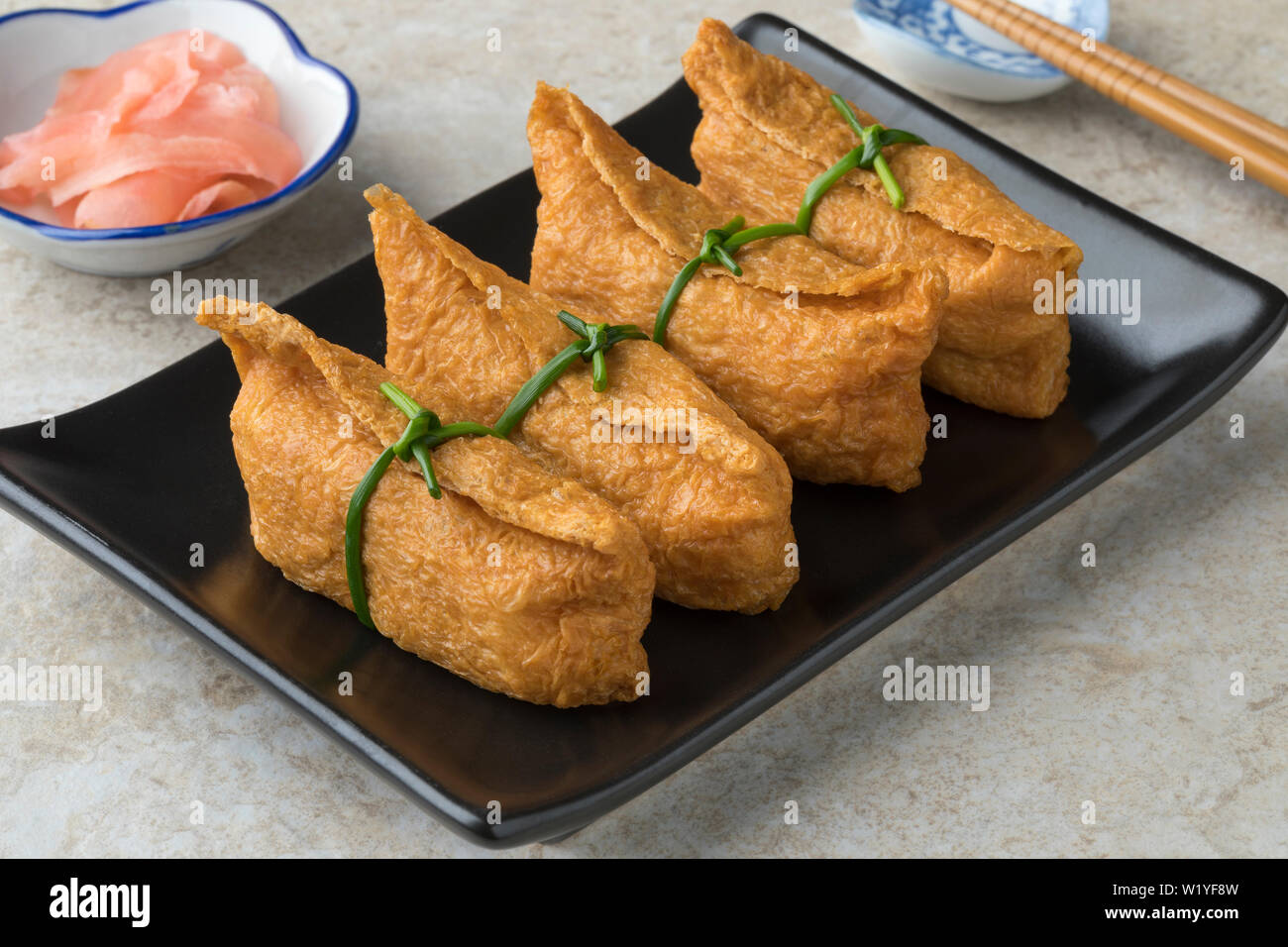 Traditional Japanese fried marinated tofu stuffed with rice, called ...