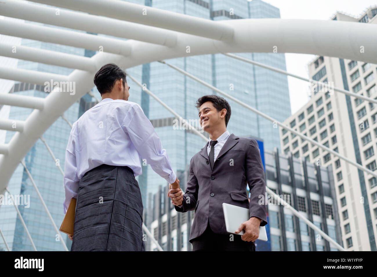 Handsome businessman partnership with handshake agreement of asean ...