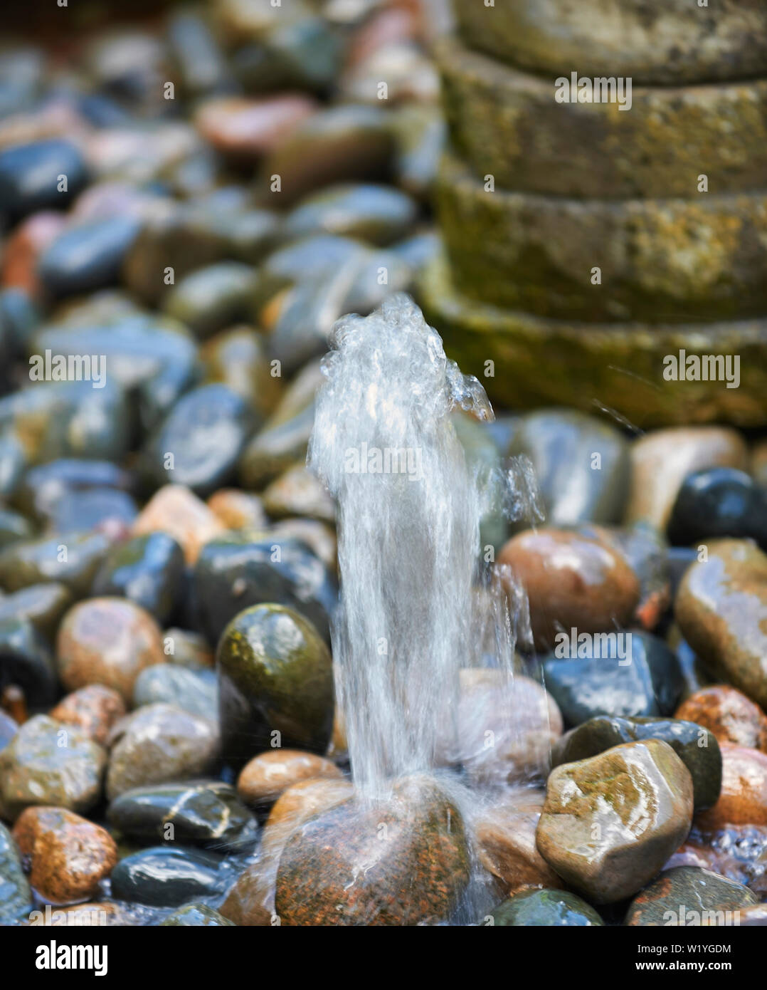 Water bubbling over wet rocks Stock Photo - Alamy