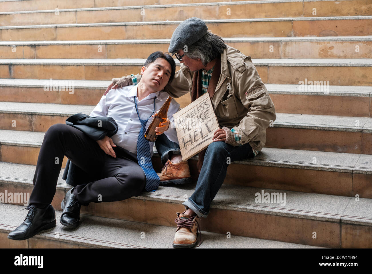 Old homeless people are listening to the problems of businessman with ...