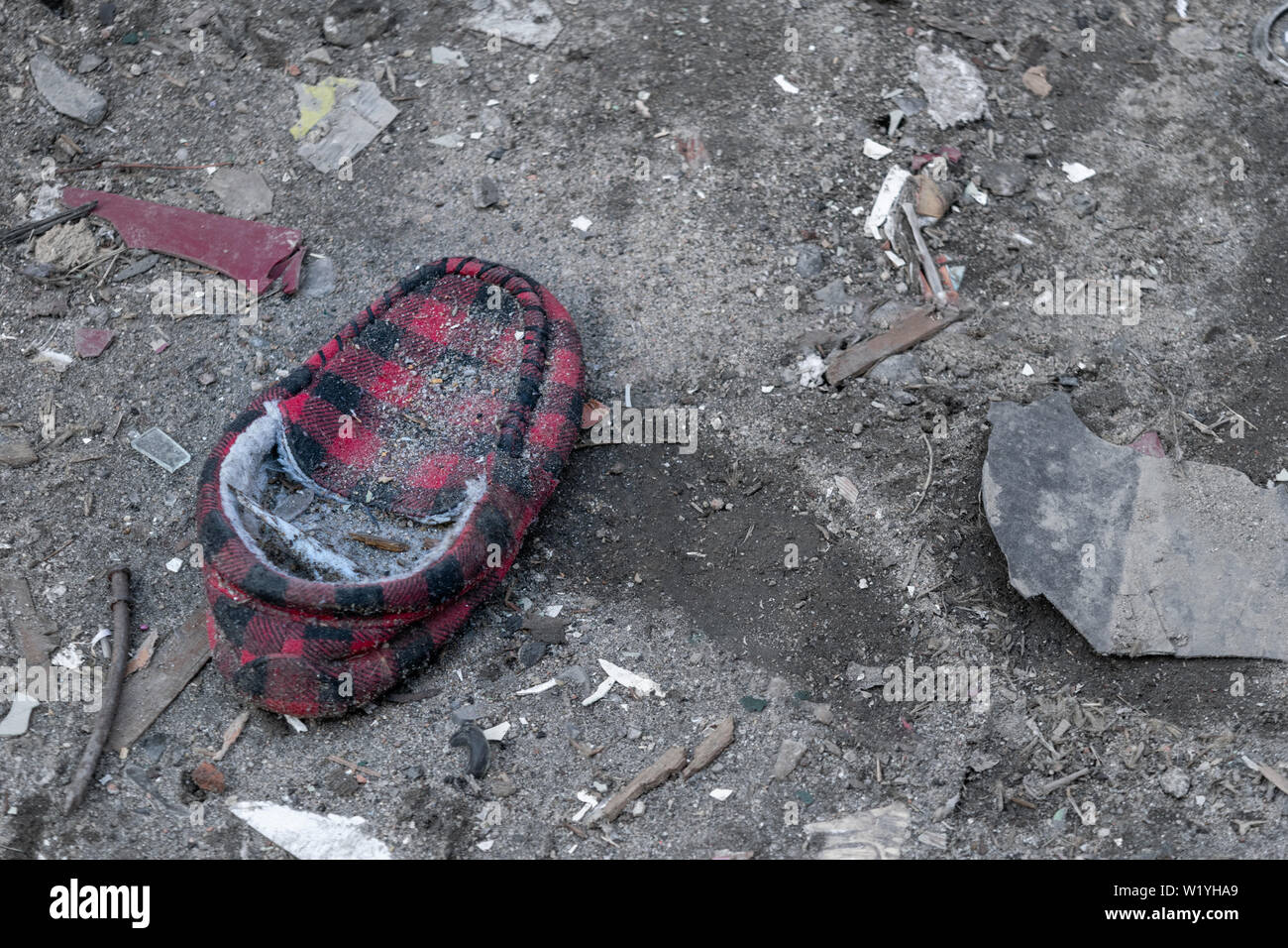 Dirty, old red and black slipper, discarded Stock Photo - Alamy