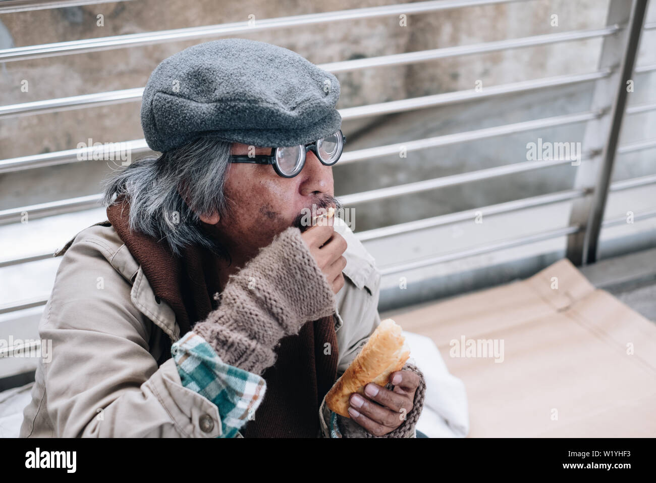 Homeless person eating hi-res stock photography and images - Alamy