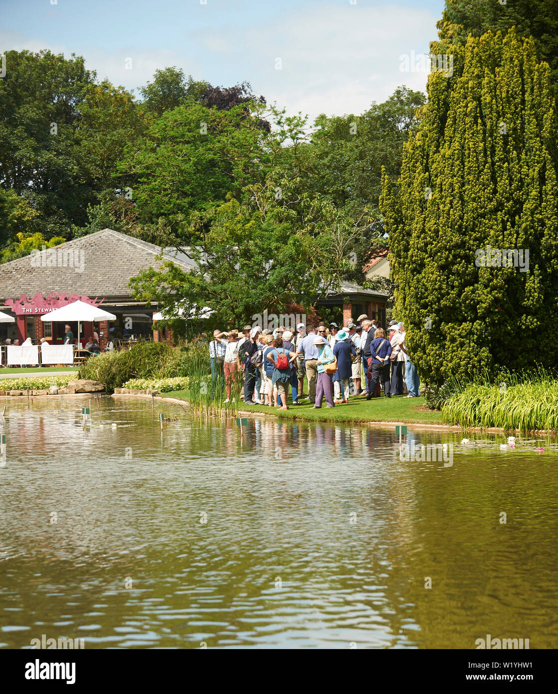 Large crowds of people at Burnby Hall Gardens, beginning a conducted ...