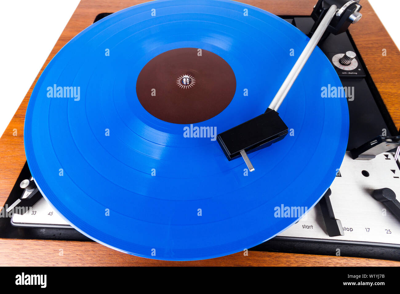 Vintage turntable with a blue vinyl isolated on white. Wooden plinth ...