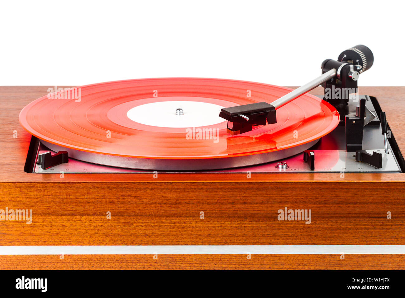 Vintage turntable with a red vinyl isolated on white. Wooden plinth ...
