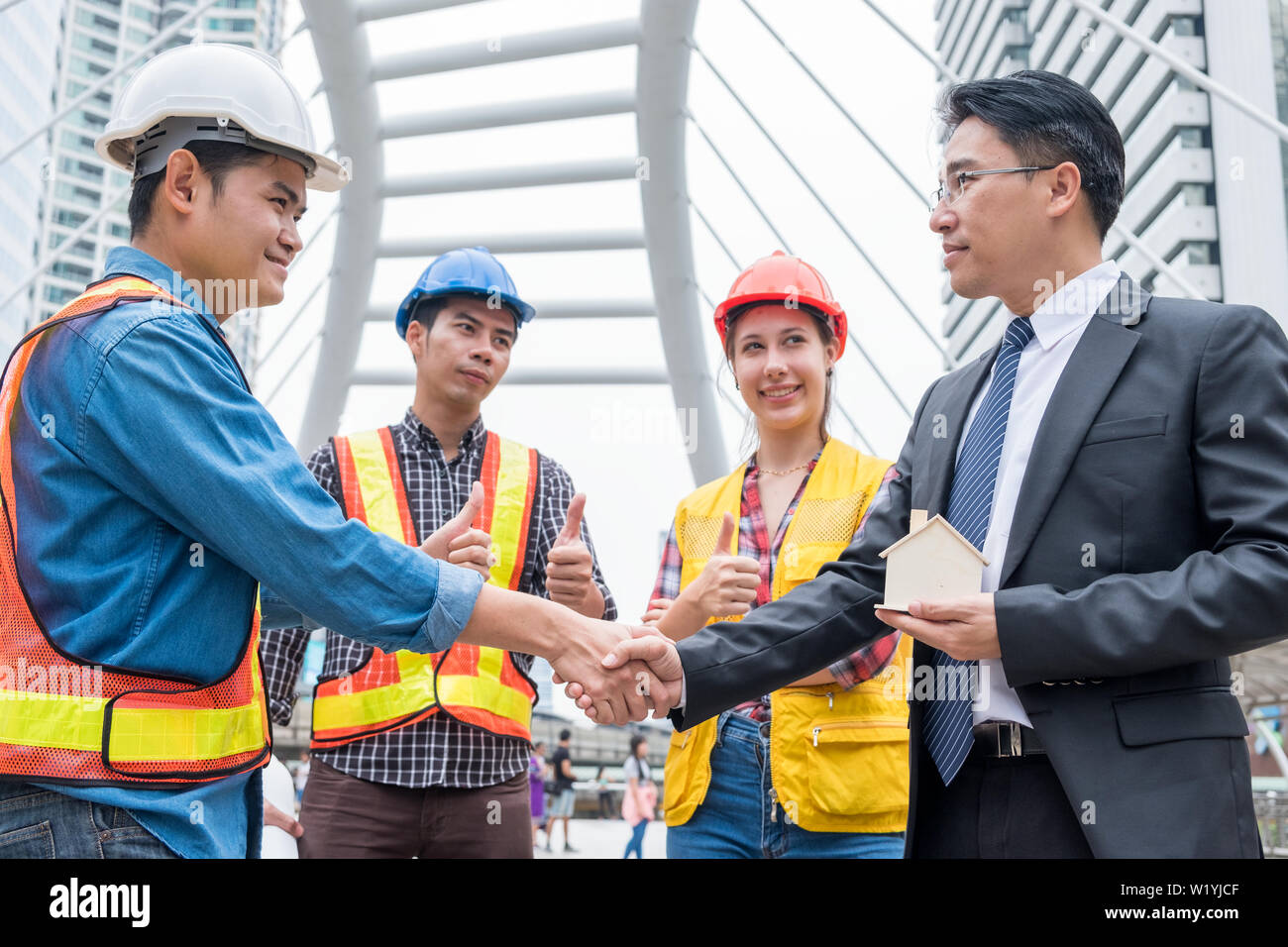 Engineer group handshake agreement with businessman for residential ...