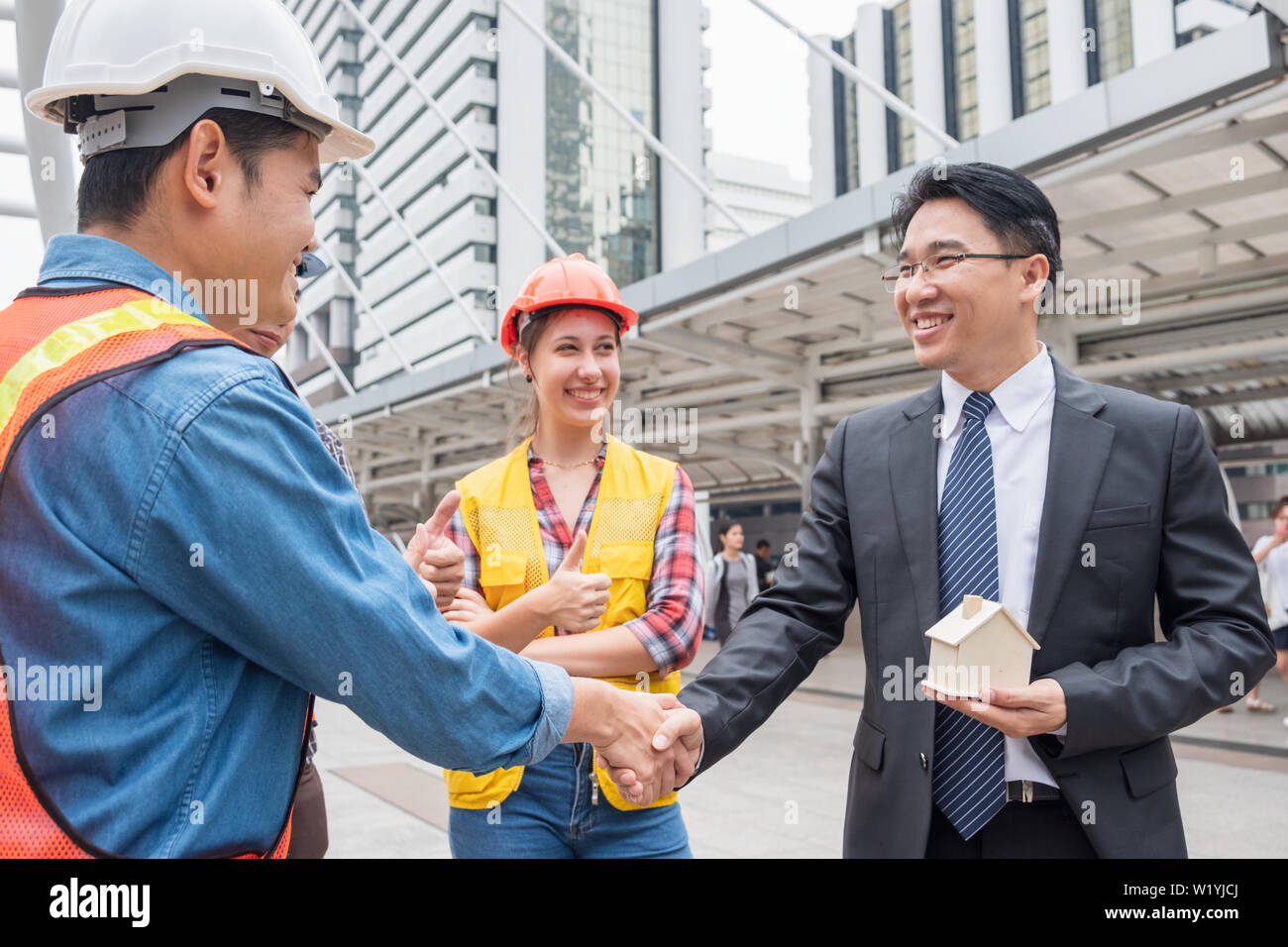 Engineer group handshake agreement with businessman for residential ... Engineer group handshake agreement with businessman for residential ...