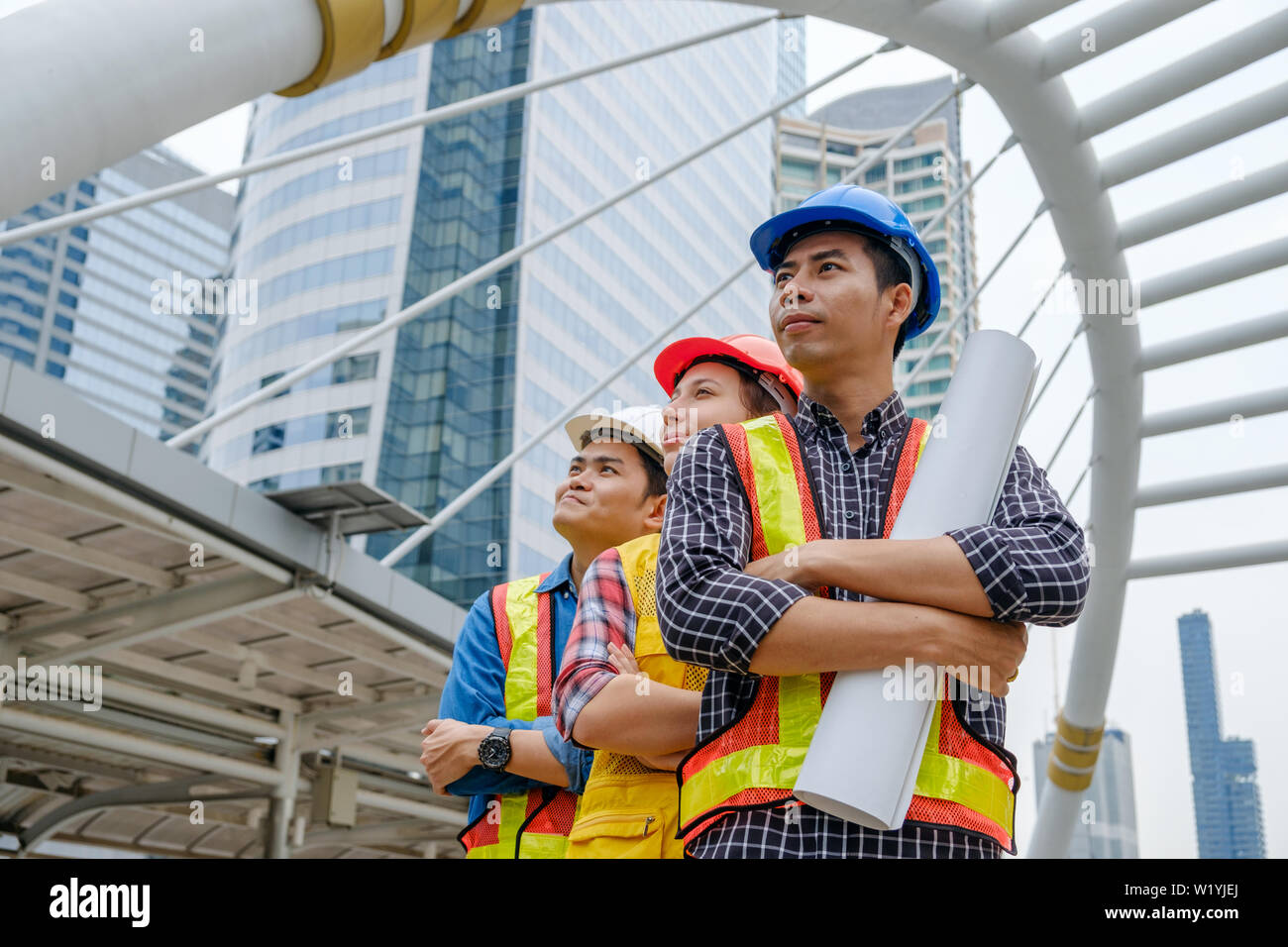Professional team engineer standing crossed arms on skyscraper ...