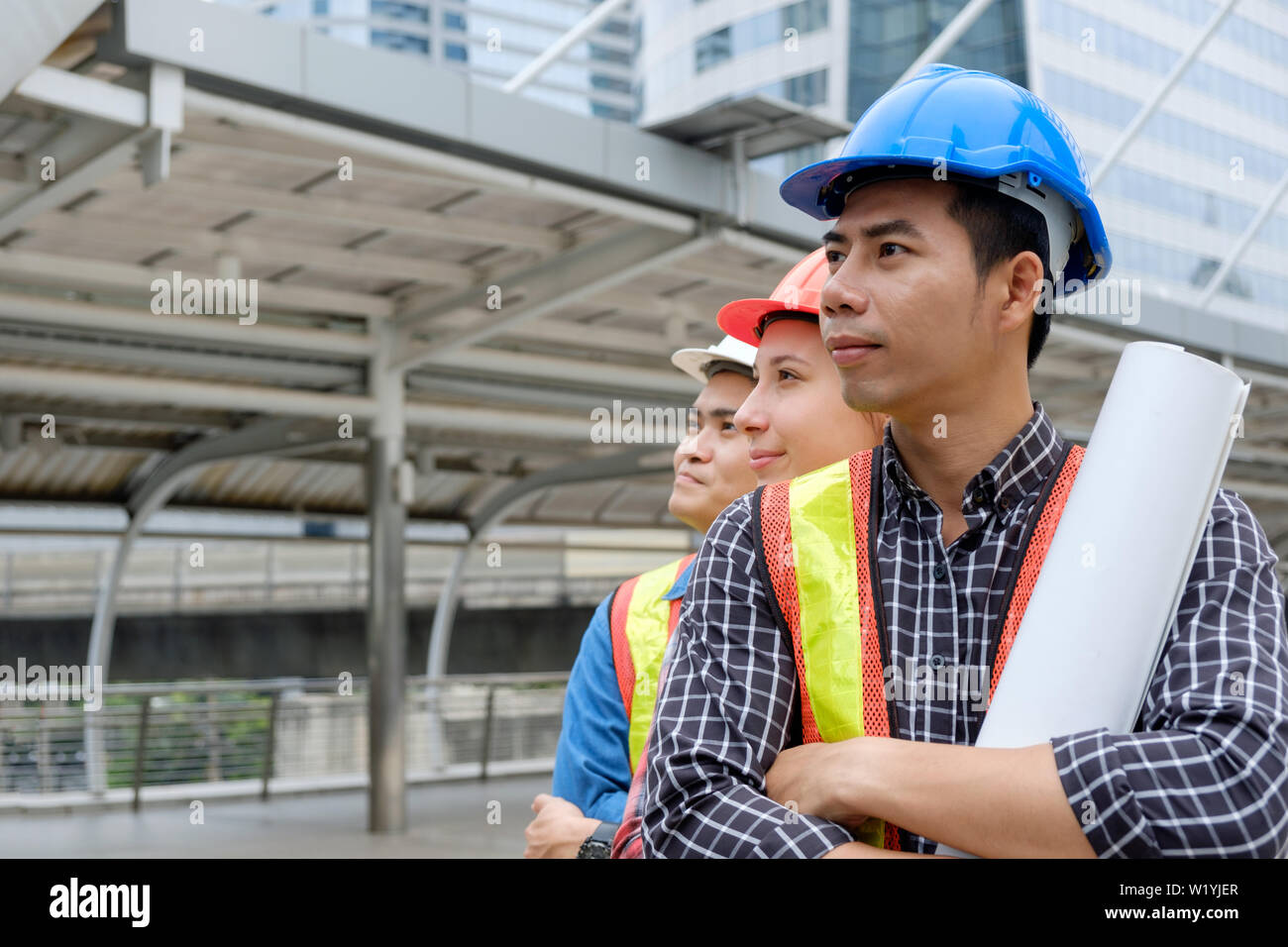 Professional team engineer standing crossed arms on skyscraper ...
